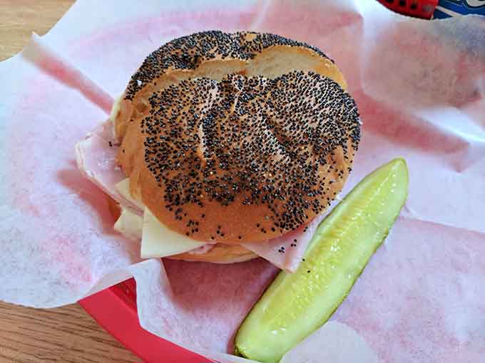 Behold the poppy seed Kaiser roll in all its glory, holding together turkey, cheese, and sprouts like an edible architectural marvel.