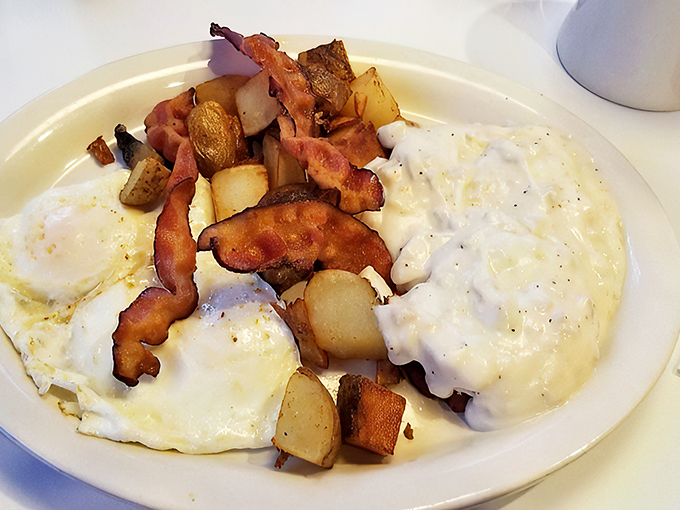 The holy trinity of breakfast! Biscuits, gravy, and bacon unite in a plate-licking trifecta of morning bliss.