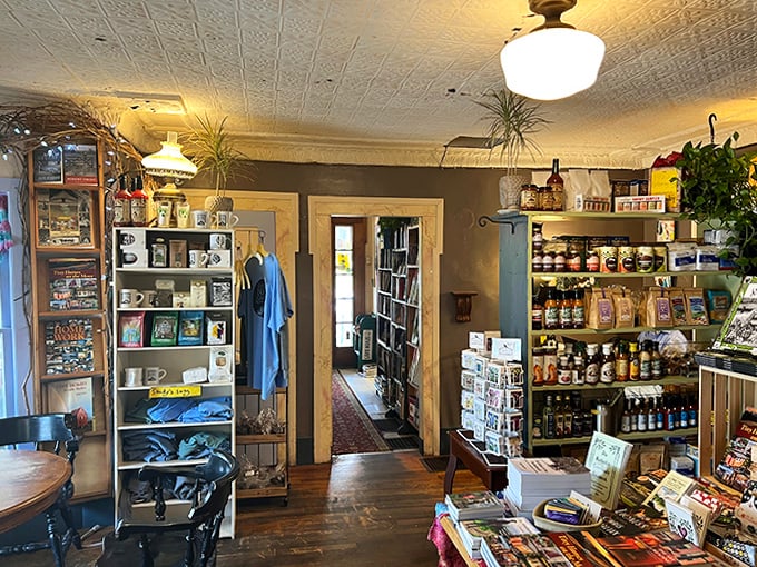 Wooden shelves create literary canyons to explore, with handwritten staff recommendations peeking out like friendly trail markers for book adventurers.