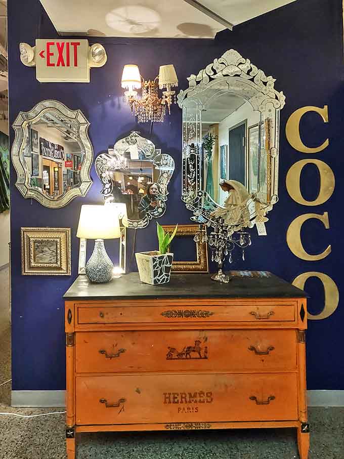 Navy walls and ornate mirrors create a luxurious backdrop that would make any fashion icon feel right at home.