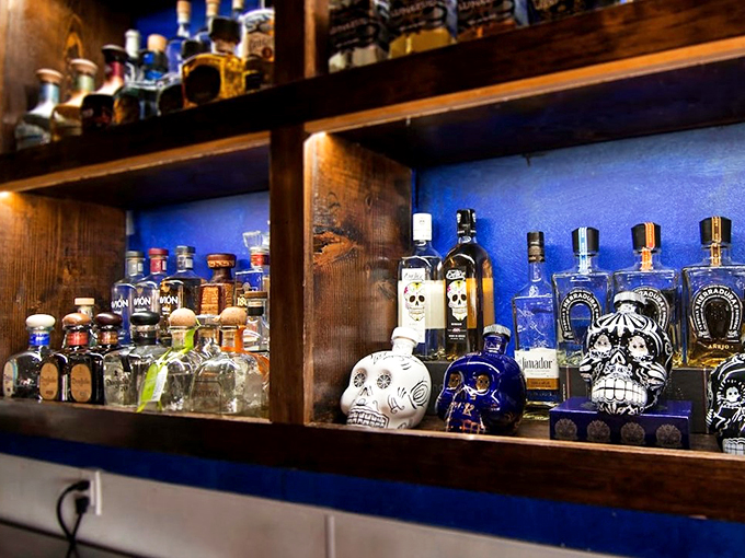 These aren't your abuela's tequila bottles - artistic skull decanters add Day of the Dead charm to the bar's impressive collection.