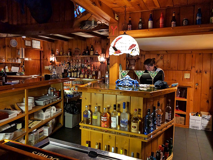 Behind this rustic bar, a lobster-shaped lamp watches over martinis and memories. It's like a maritime speakeasy met a cozy cabin.