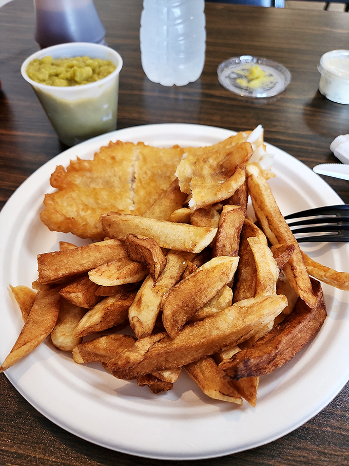 Golden-battered fish rests atop a mountain of hand-cut chips &ndash; crispy outside, fluffy inside &ndash; the platonic ideal of Britain's national dish.