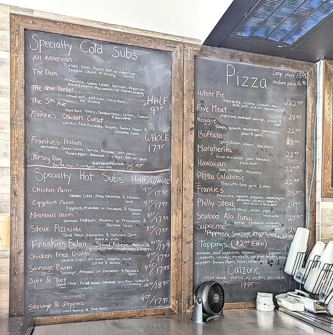 The chalkboard menu showcases an impressive array of Italian classics – from specialty subs to pizzas that would make any New Yorker nod in approval.