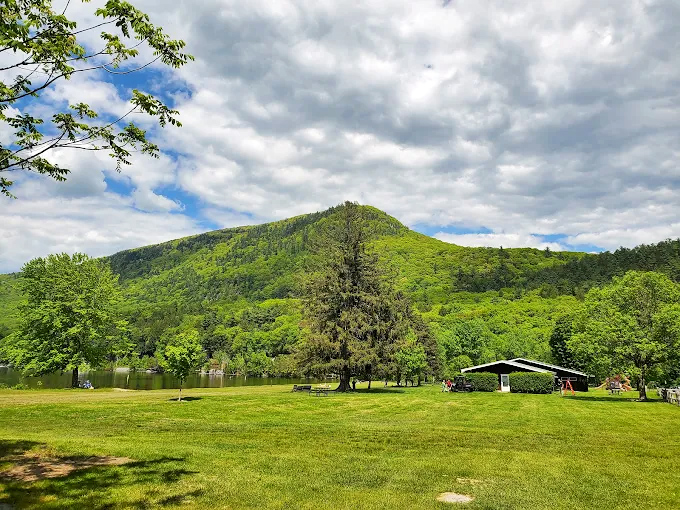 Green Mountain majesty stands guard over the park, creating a dramatic backdrop for every outdoor adventure.