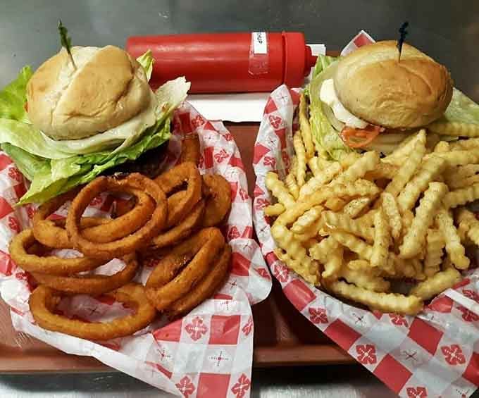 Two burgers flanked by onion rings and fries, because choosing between sides is for quitters.