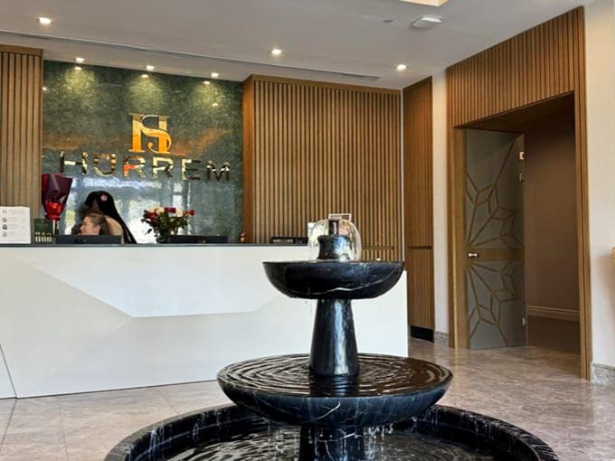 Reception Area: The bubbling fountain centerpiece whispers "relax" while the elegant desk says "we've got this" &ndash; first impressions done right.