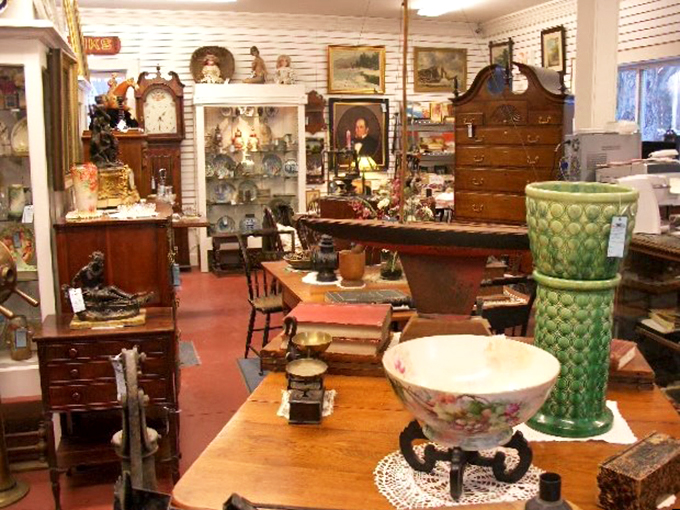 Elegant period furniture and decorative pieces create a museum-like display, each item telling its own story of craftsmanship.