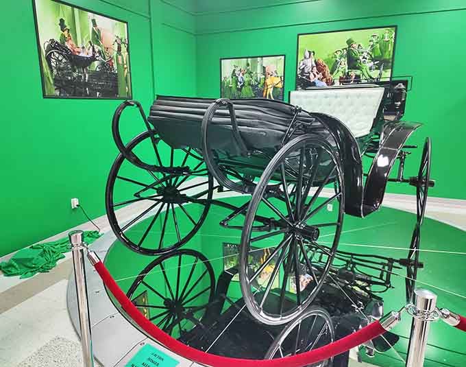 This elegant carriage sits behind velvet ropes, a reminder that even before automobiles ruled the roads, showmanship required style.