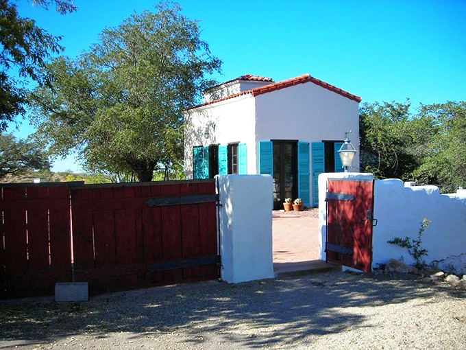 The historic Kannally Ranch House stands as a Mediterranean mirage in the Arizona desert, its white walls gleaming under endless blue skies.