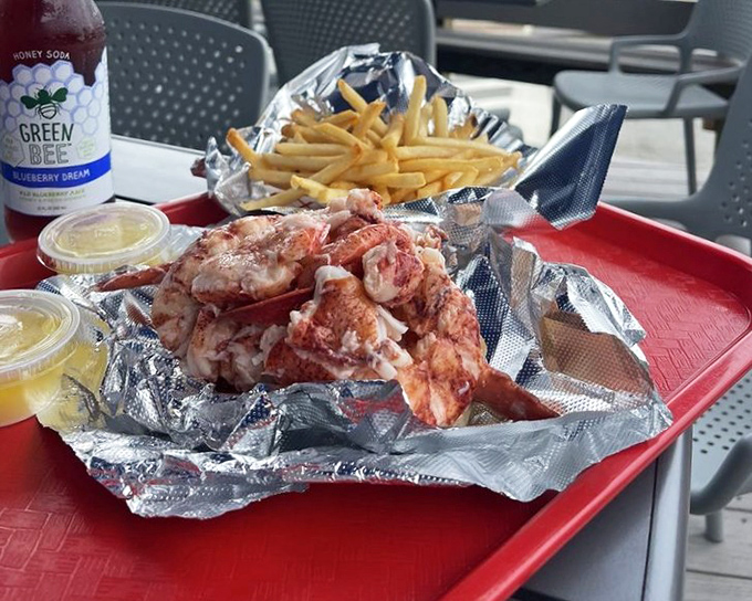 Lobster roll perfection: more meat than bun, served with golden fries and that essential squeeze of lemon. Summer on a plate!