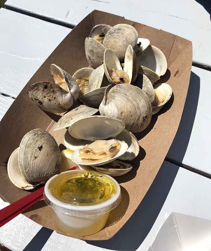 Grilled clams with those beautiful char marks and a side of melted butter, this is what seafood dreams are made of.