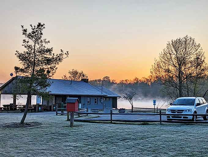 The lakeside cabin emerges from morning fog like something from a storybook, promising adventures for early risers.
