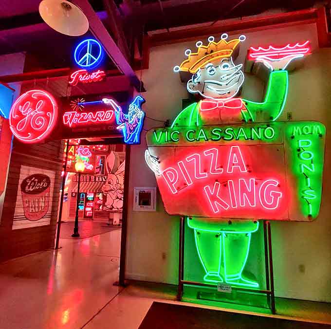 Pizza King waves hello in neon splendor, surrounded by peace signs and corporate logos that once lit up America's nighttime landscape.