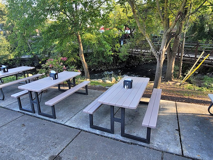 Riverside dining with a side of serenity. These picnic tables are nature's VIP seats for your Coney Island feast.