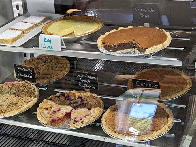 Decisions, decisions! The pie case showcases a rainbow of flavors from key lime to chocolate chess, each one more tempting than the last.