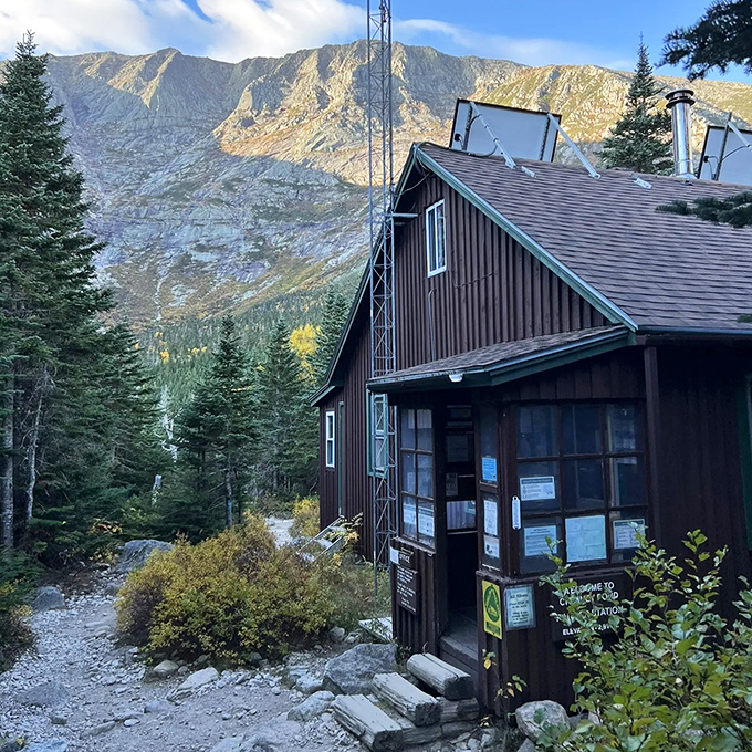 This rustic ranger station stands guard like a woodland sentinel, offering guidance before your mountain adventure begins.