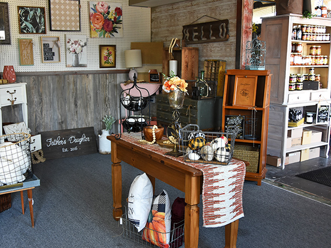 Rustic meets refined in this vendor space where weathered wood backdrops showcase farmhouse chic treasures and handcrafted signs.