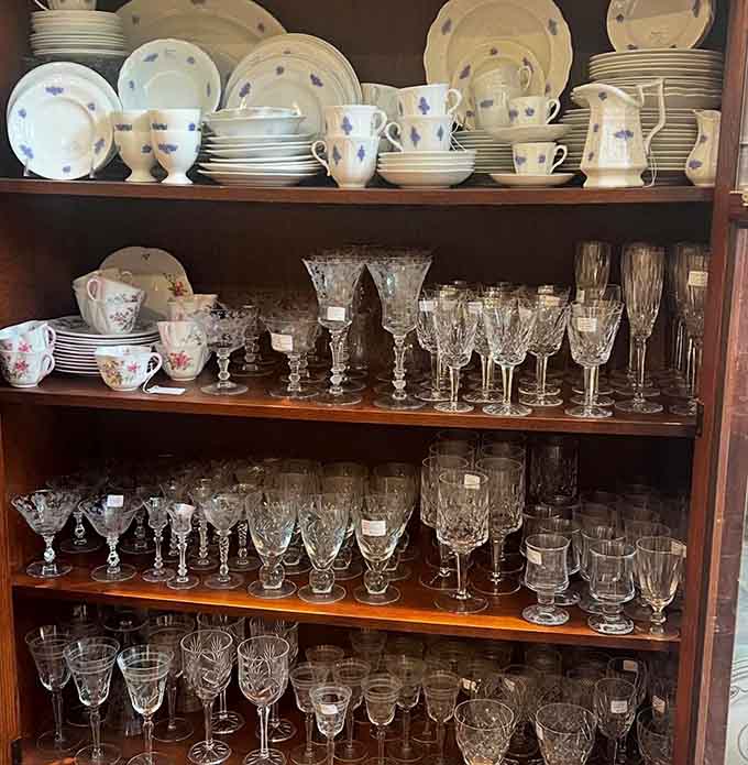 Crystal and glassware sparkle like a fancy dinner party frozen in time, waiting for someone to toast with them again.