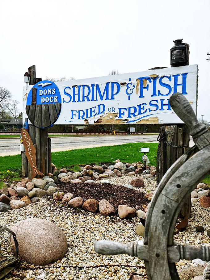 Weather-worn wood and weathered wisdom&mdash;this rustic sign promises both fried and fresh catches, surrounded by Great Lakes stones.
