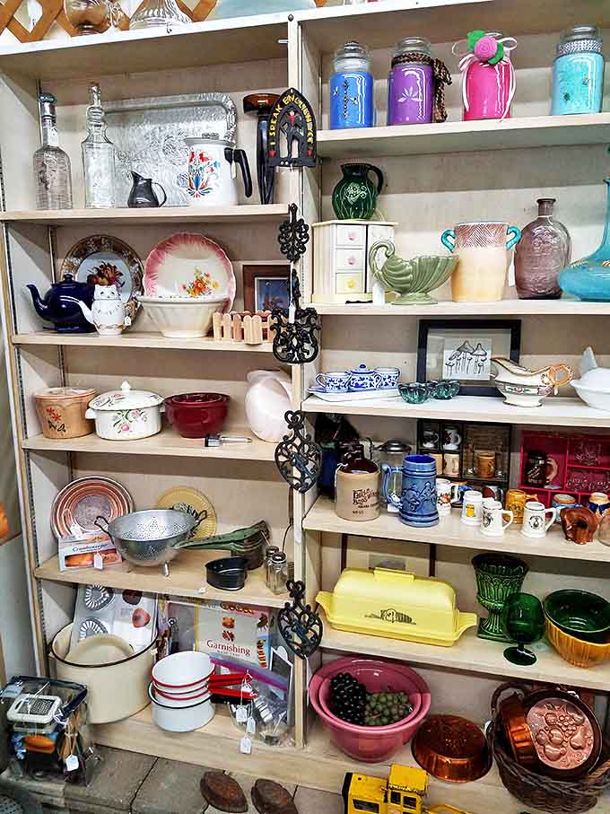 Delicate teacups and colorful dishware line these shelves, each piece whispering stories of family dinners and special occasions from decades past.