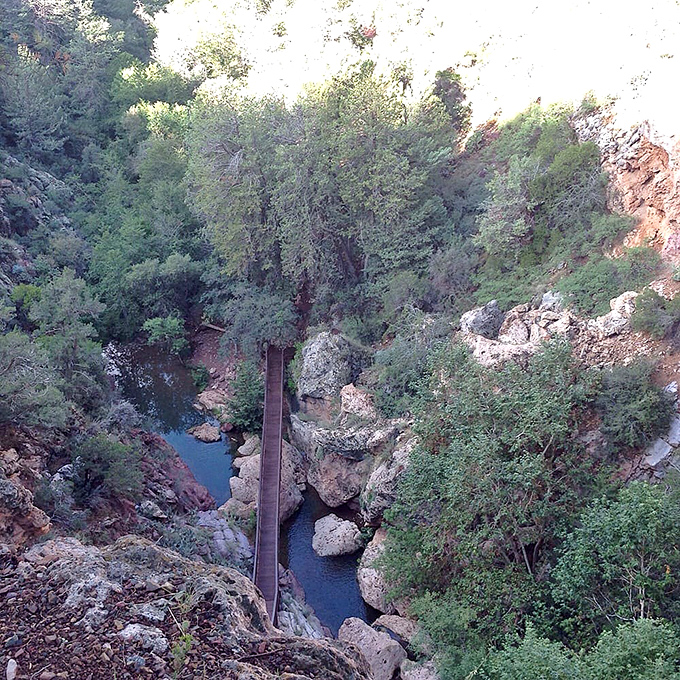 From above, the wooden boardwalk appears like a human afterthought against nature's grand design, a humble pathway through geological majesty.