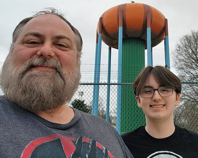 Visitors often pose for photos with the tower, creating memories that inevitably begin with "Remember that giant pumpkin we saw?"