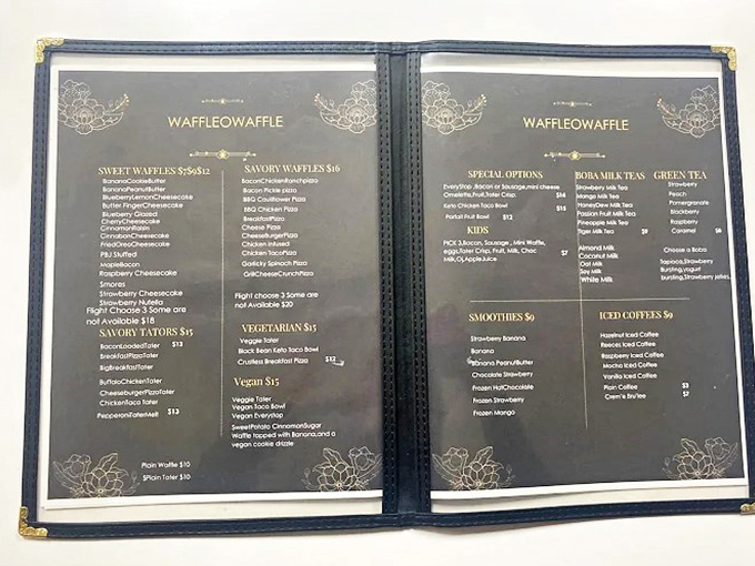Menu: A leather-bound treasure map of waffle possibilities &ndash; sweet on one side, savory on the other, with each description promising a unique flavor adventure.