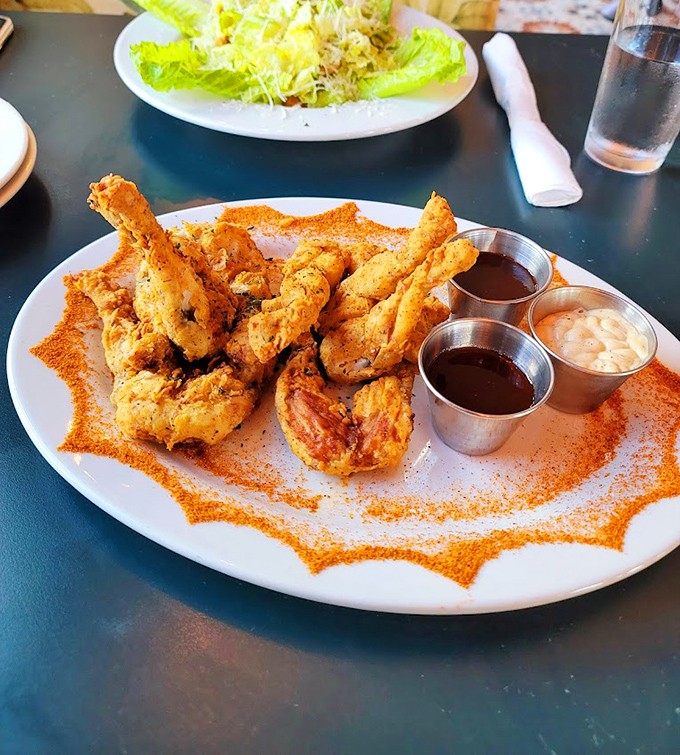 Wing perfection achieved! Golden-brown messengers from poultry paradise arrive with three dipping companions, though they're spectacular enough to fly solo.