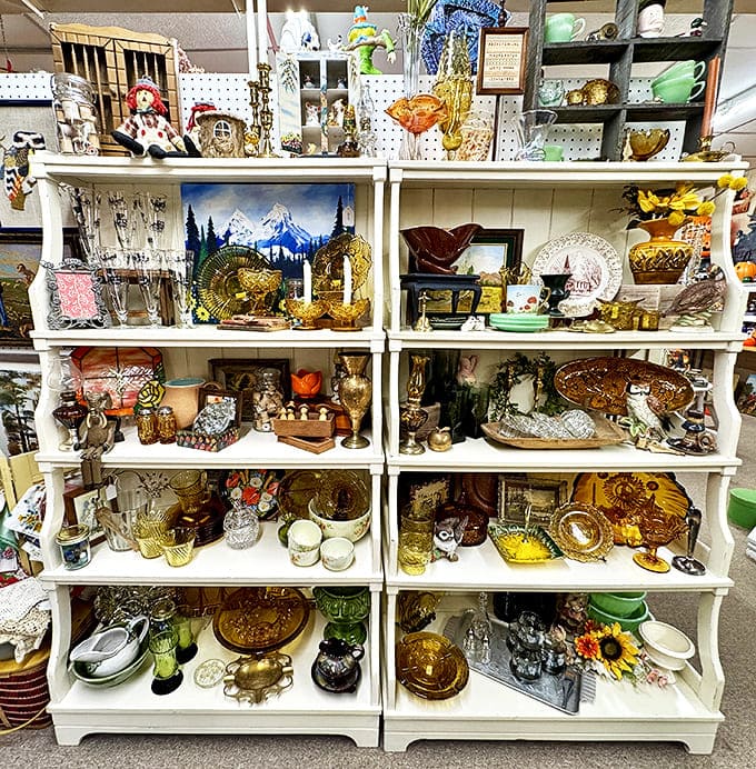 Shelves laden with amber glass and vintage dishware catch the light, each piece whispering stories of family dinners and special occasions from decades past.