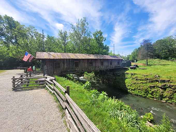 This covered bridge isn't just functional, it's the kind of rustic charm that makes you want to slow down and actually enjoy the view instead of rushing past.