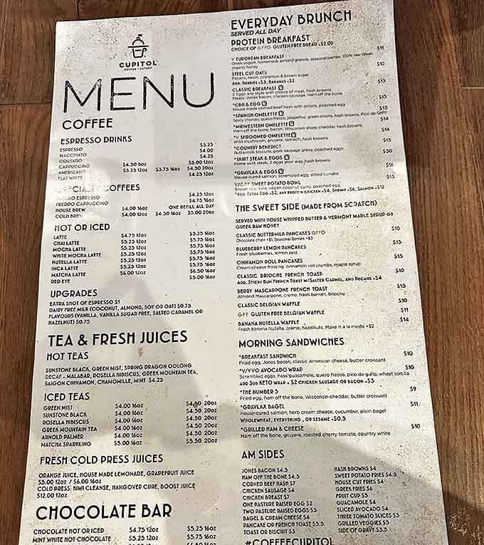 The menu board reveals a treasure map of culinary delights, from all-day brunch to handcrafted espresso drinks.