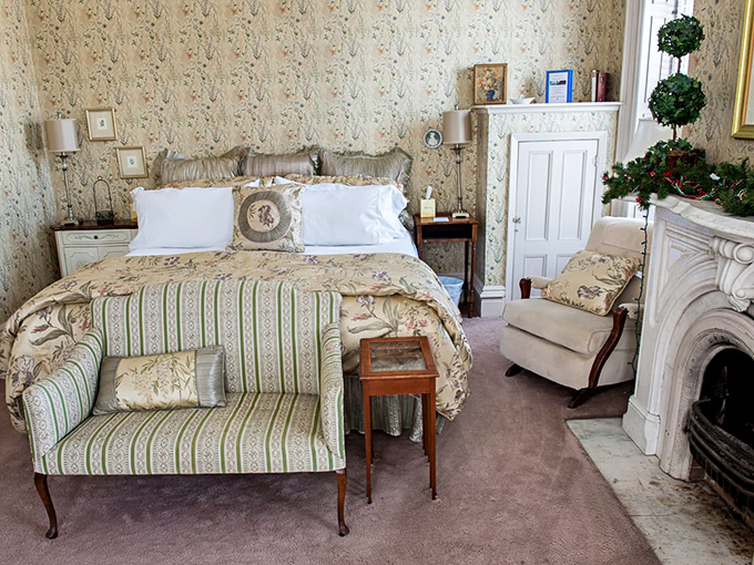 Drift into 19th-century dreams in bedrooms where floral wallpaper and period furnishings create a cocoon of historical luxury.