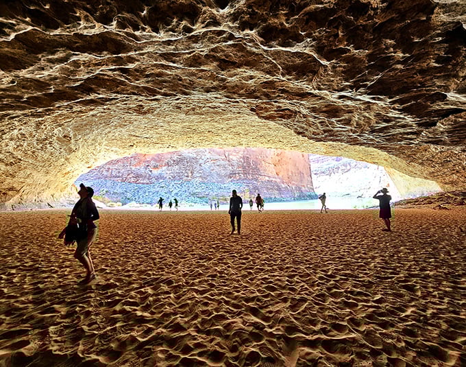 The cavern's sandy floor stretches like nature's plushest carpet, inviting bare feet and spontaneous cartwheels from even the most dignified visitors.