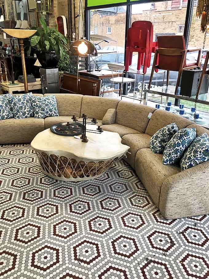 This curved sectional sofa would make Don Draper himself jealous &ndash; note the artful coffee table that completes the conversation area.