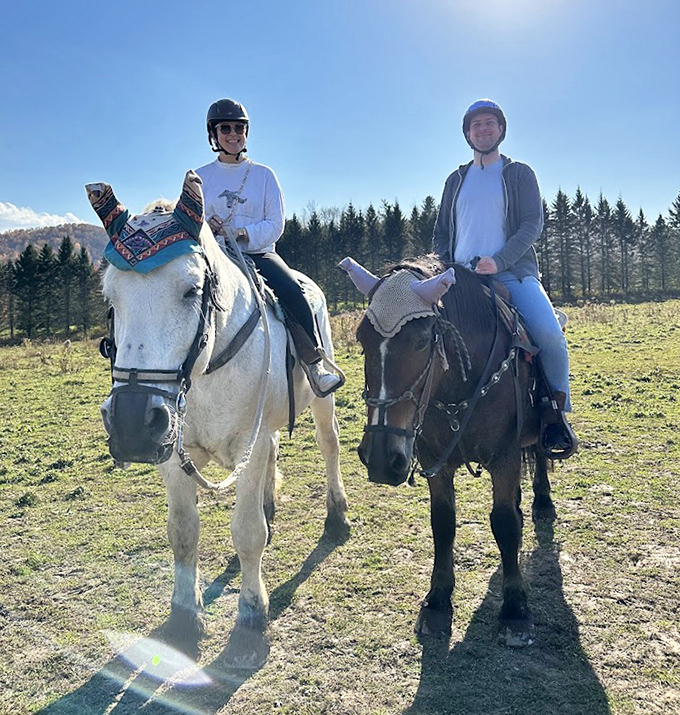 Happy riders pause for a moment, their smiles as bright as the autumn foliage surrounding them on this perfect Vermont day.