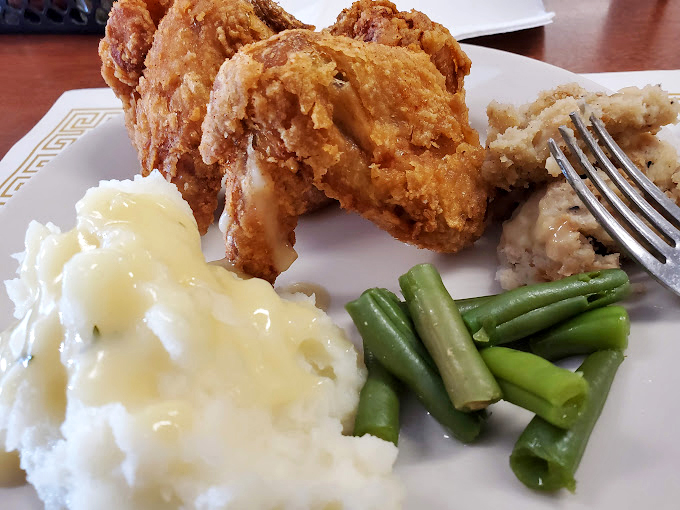 A plate of pure comfort: crispy chicken, creamy mashed potatoes, and vibrant veggies. It's like a hug for your stomach.
