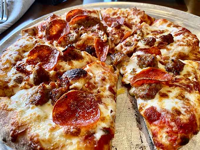 This meat-lover's masterpiece loaded with pepperoni, sausage, and bacon shows what happens when carnivores design the perfect pizza.