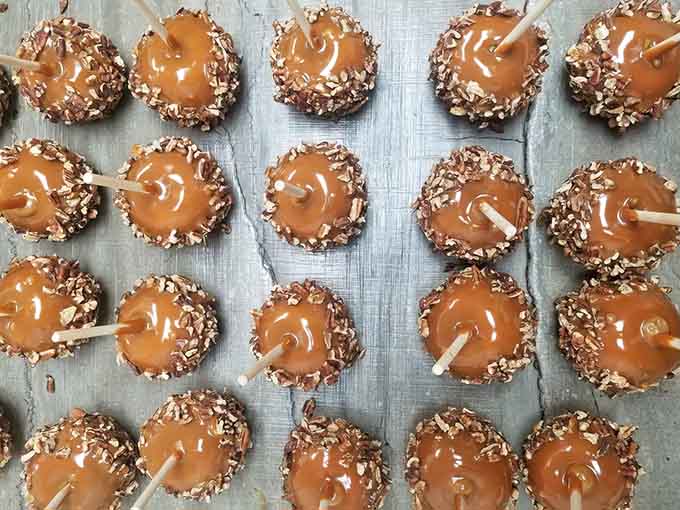 Caramel apples get the gourmet treatment here, dressed up in chocolate and toppings like they're heading to the candy prom.