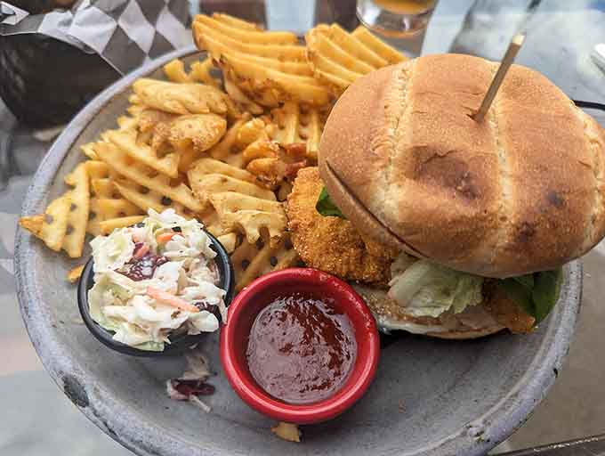 The whitefish sandwich arrives golden and generous, proving that sometimes simple preparations let quality ingredients shine brightest of all.