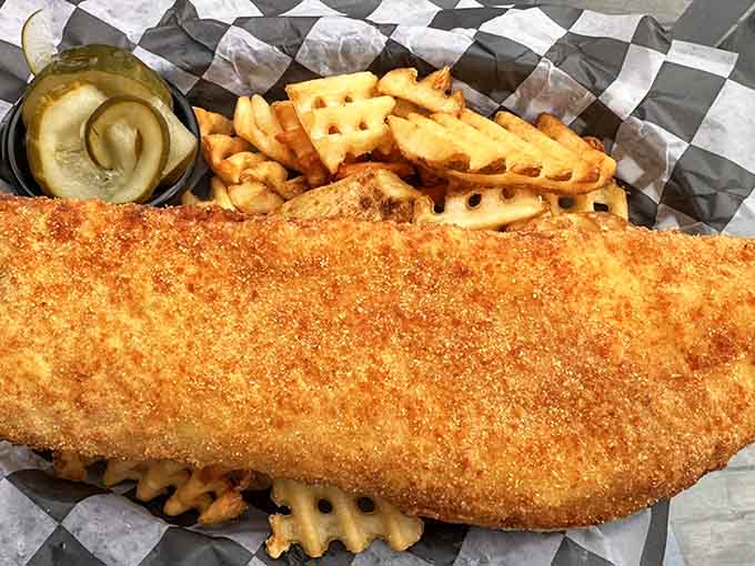 Behold the golden-crusted perfection that has people driving hours and planning vacations around a plate of fish and waffle fries.