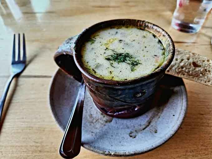 That first spoonful of chowder hits different when it's this creamy, this fresh, and served in handcrafted pottery that makes the whole experience feel special.