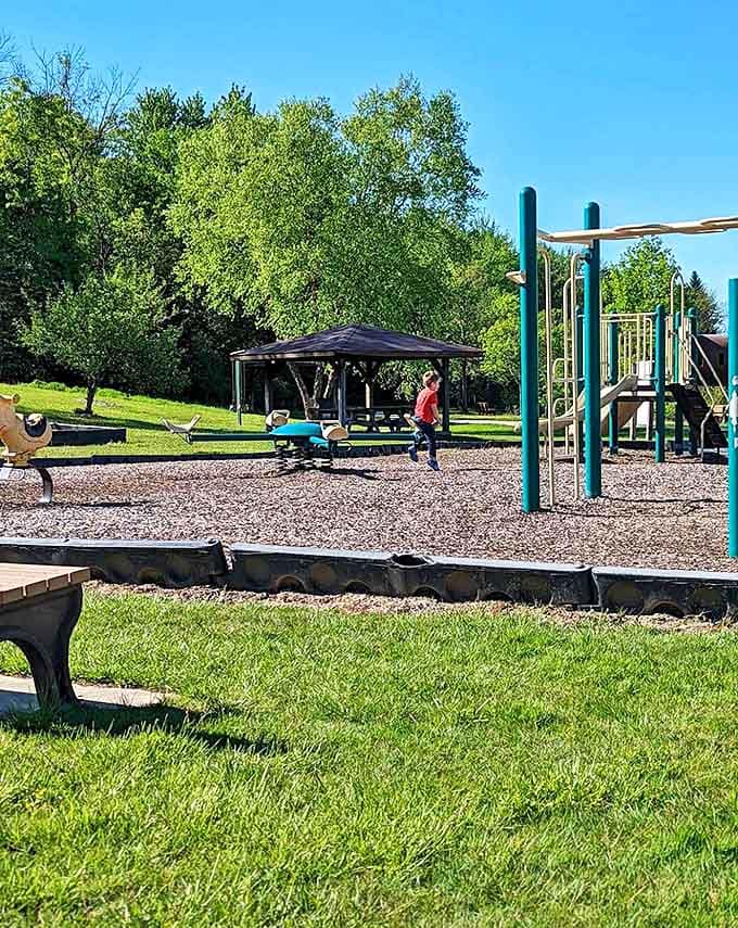Colorful playground equipment beckons to young adventurers, promising hours of giggles and grass-stained knees under watchful oak trees.