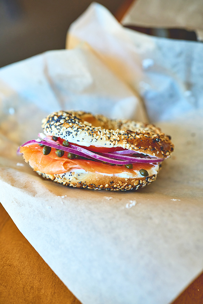 A classic reimagined: smoked salmon nestles against cream cheese on an everything bagel, with red onion adding that perfect bite.