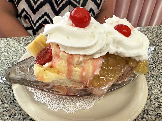 This isn't just dessert, it's architecture &ndash; a classic banana split arrives like royalty on its silver boat, crowned with whipped cream and cherries.