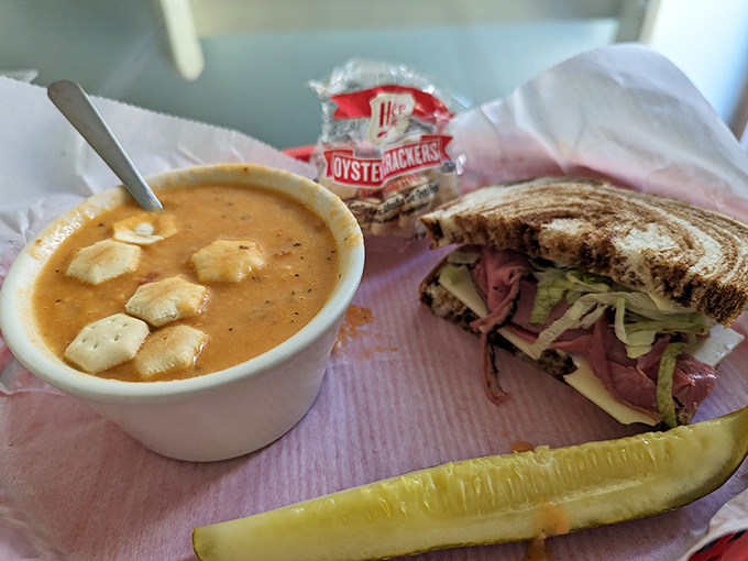 That's what a real deli sandwich looks like, folks, generous portions and fresh ingredients wrapped in pink paper perfection.