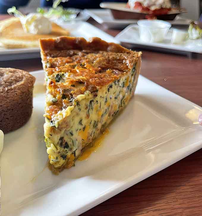 Behold the quiche in all its golden glory, a savory masterpiece that'll haunt your dreams in the best way.