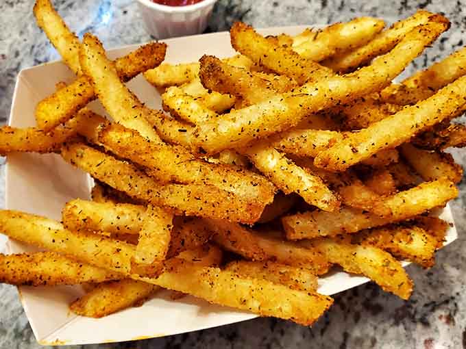 Golden, crispy, and generously seasoned with Cajun spices, these fries are the supporting actors that steal every scene.