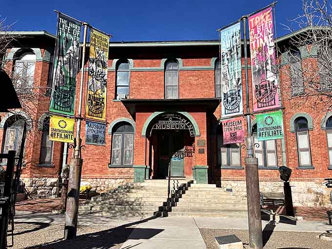 The Bisbee Mining & Historical Museum stands proud in its brick glory, holding stories of boom times and hard work behind those arched doorways and vintage banners.