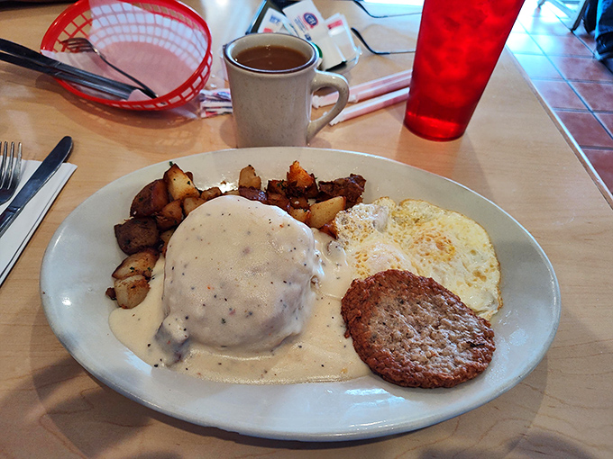 This isn't just breakfast; it's edible architecture &ndash; a biscuit foundation supporting a gravity-defying gravy masterpiece that demands to be savored.
